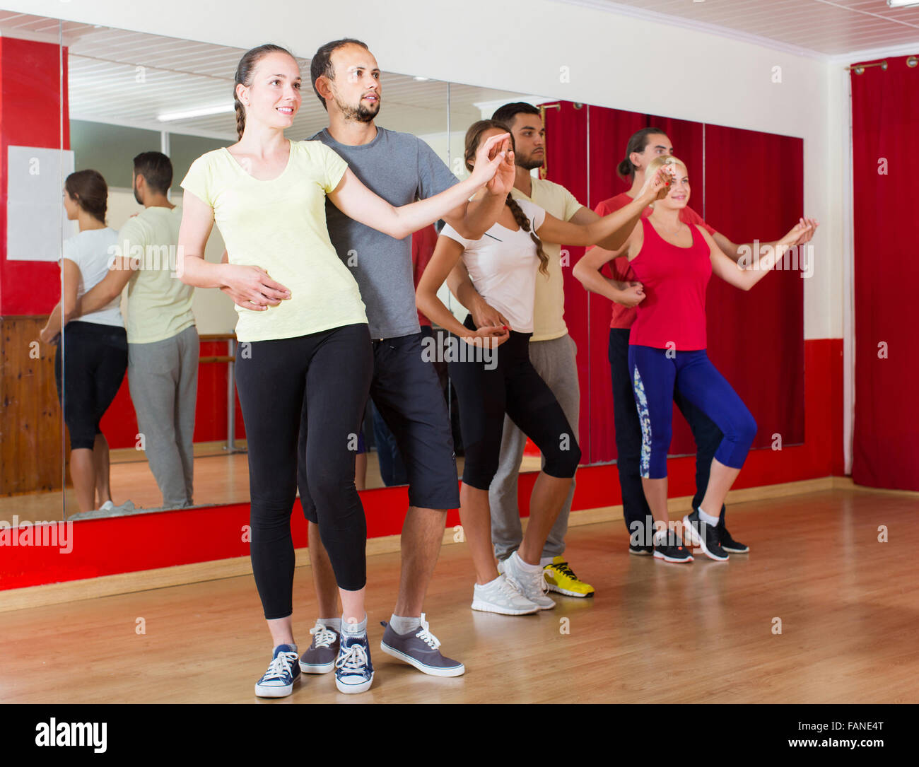 Group of smiling american people dancing salsa in studio Stock Photo ...
