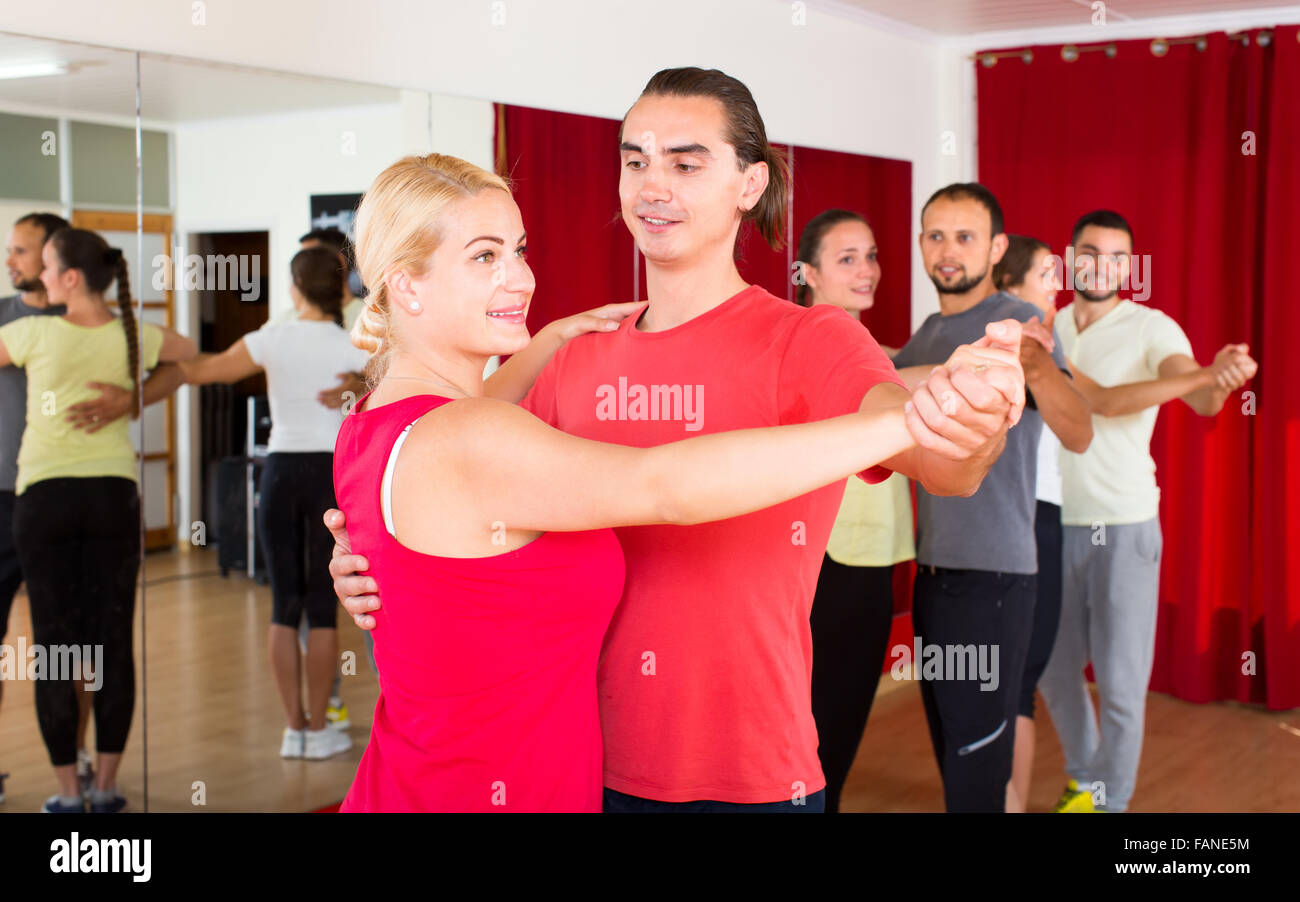 Expressive couple learning to dance slow dances in a dancing studio ...