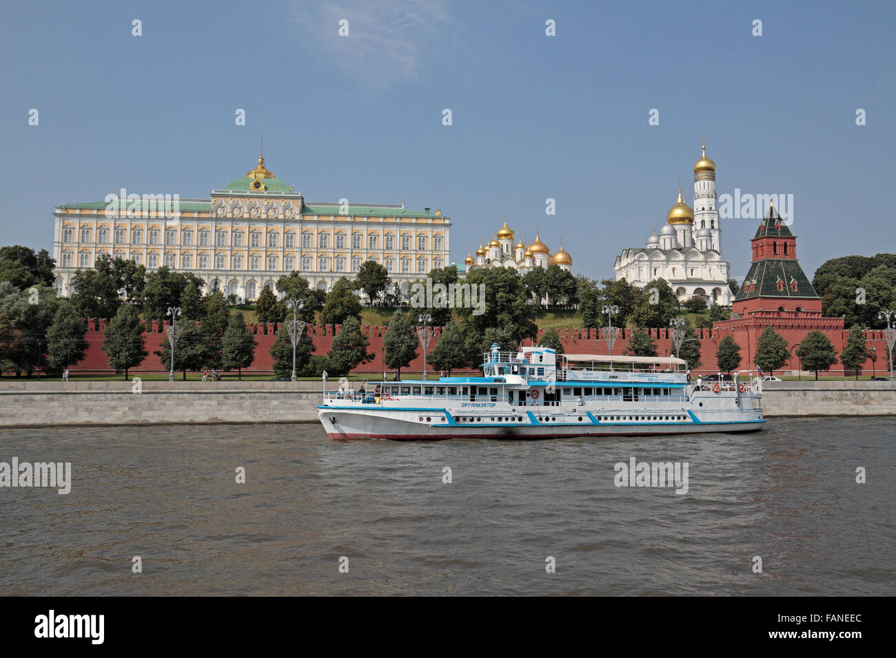 A tourist boat on the Moskva River passes the Great Kremlin Palace and ...