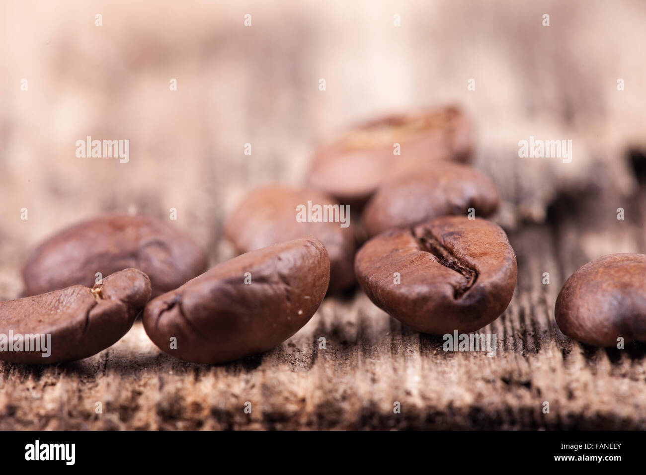 grains of coffee on rough wooden surface closeup Stock Photo - Alamy