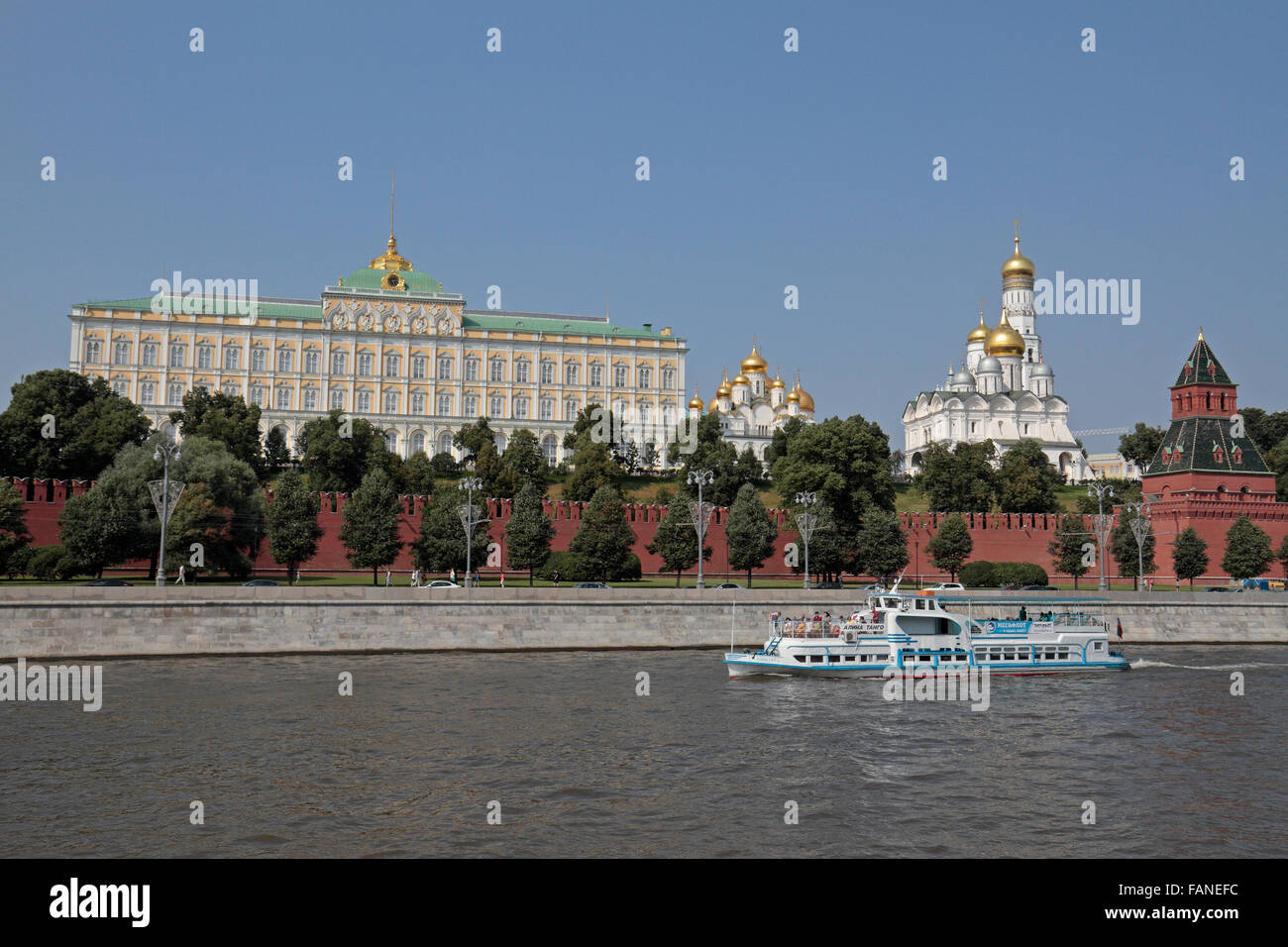 A tourist boat on the Moskva River passes the Great Kremlin Palace and ...