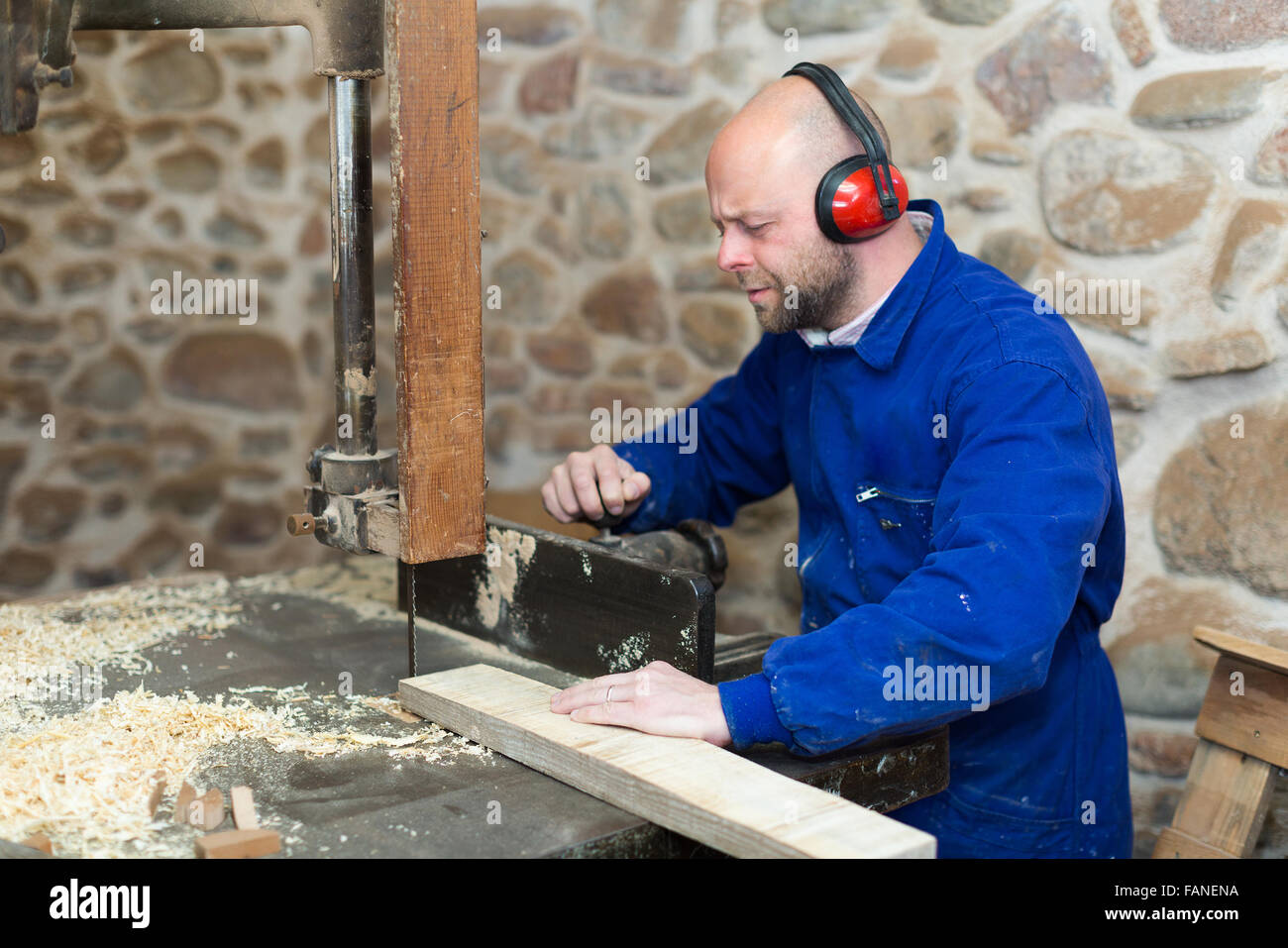 Professional worker working on a machine at wood workshop Stock Photo ...