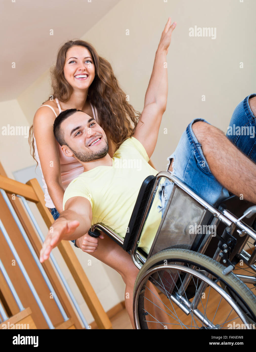 Happy friends with smiling man on wheelchair in playful mood Stock ...