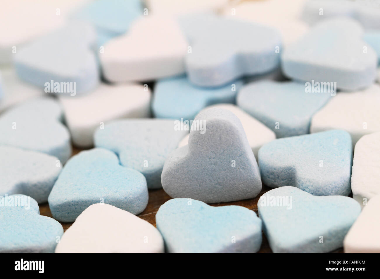 Blue and white sugar hearts spread out on flat surface Stock Photo - Alamy