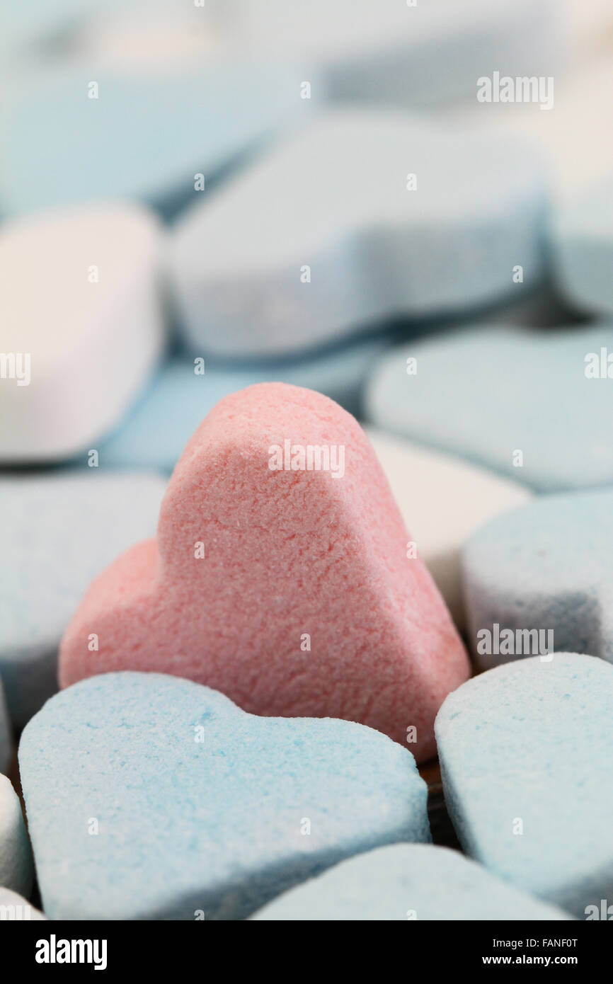 Pink sugar heart sticking out of white and blue sugar hearts Stock ...
