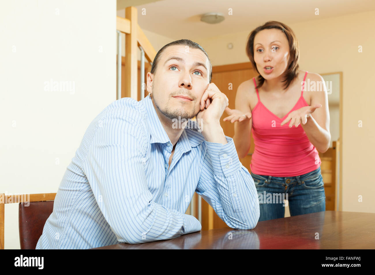 Family conflict. Sad man listening to his angry woman at home Stock ...