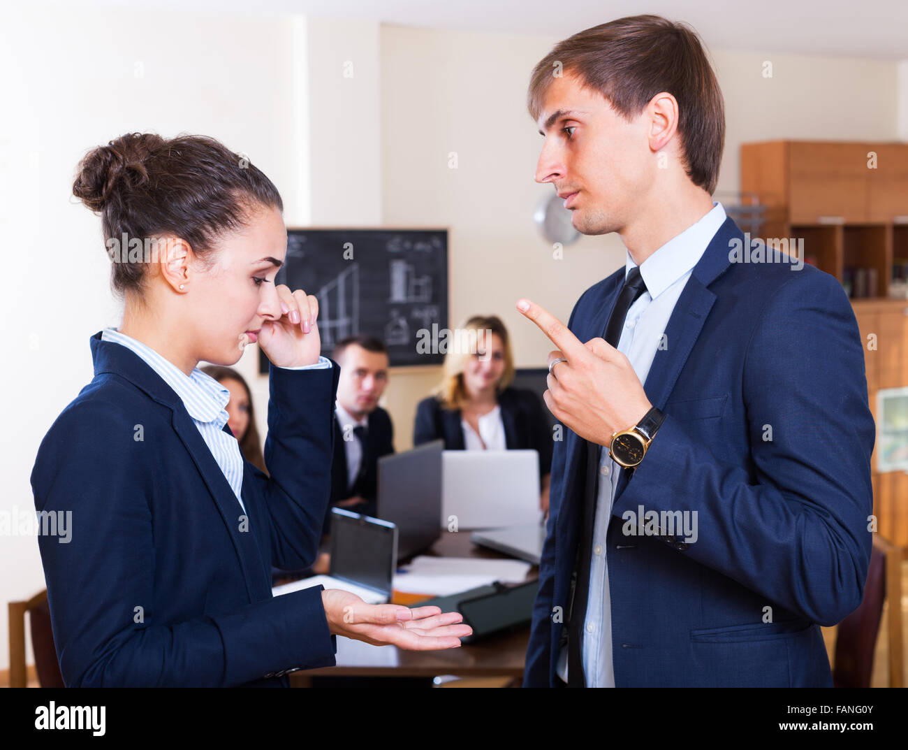Portrait of angry boss and upset employee in office interior Stock ...