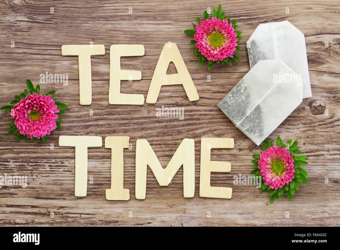 Tea time written with wooden letters, tea bags and pink daisies Stock ...