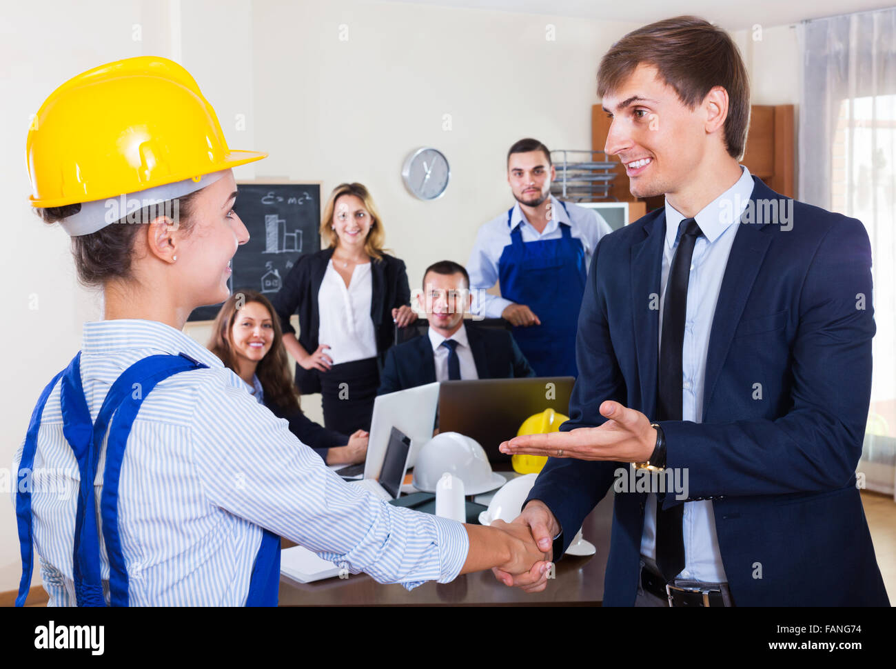 Professional planners with a helmets posing at the architecture bureau ...