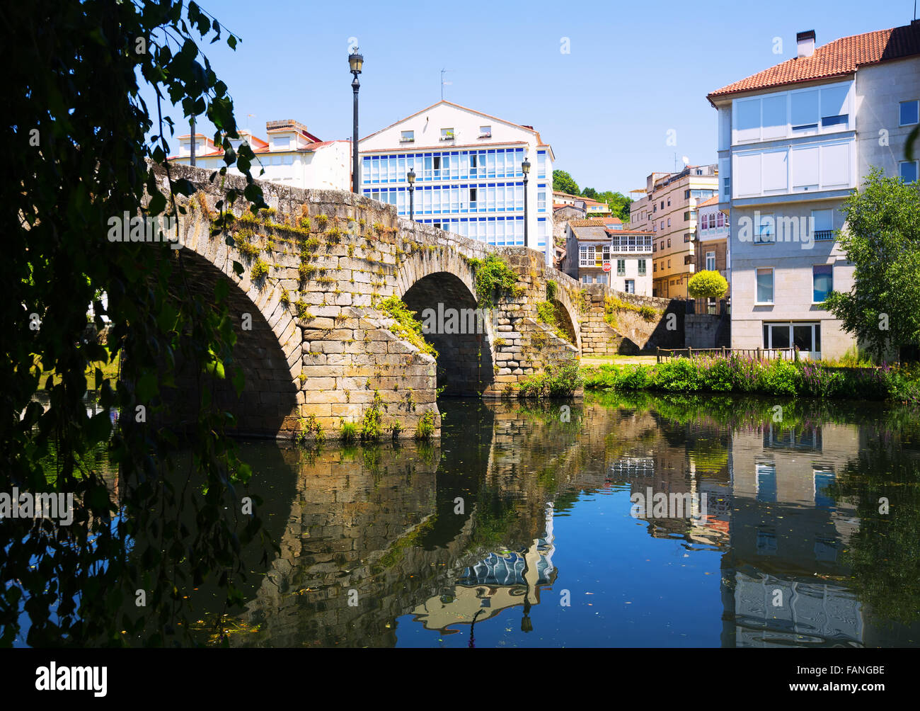 river and old stone bridge at Monforte de Lemos in sunny summer day ...