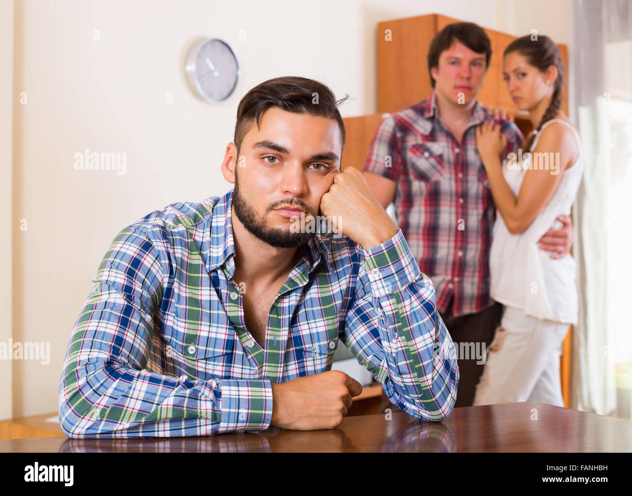 Three unhappy partners having troubles at home interior Stock Photo - Alamy