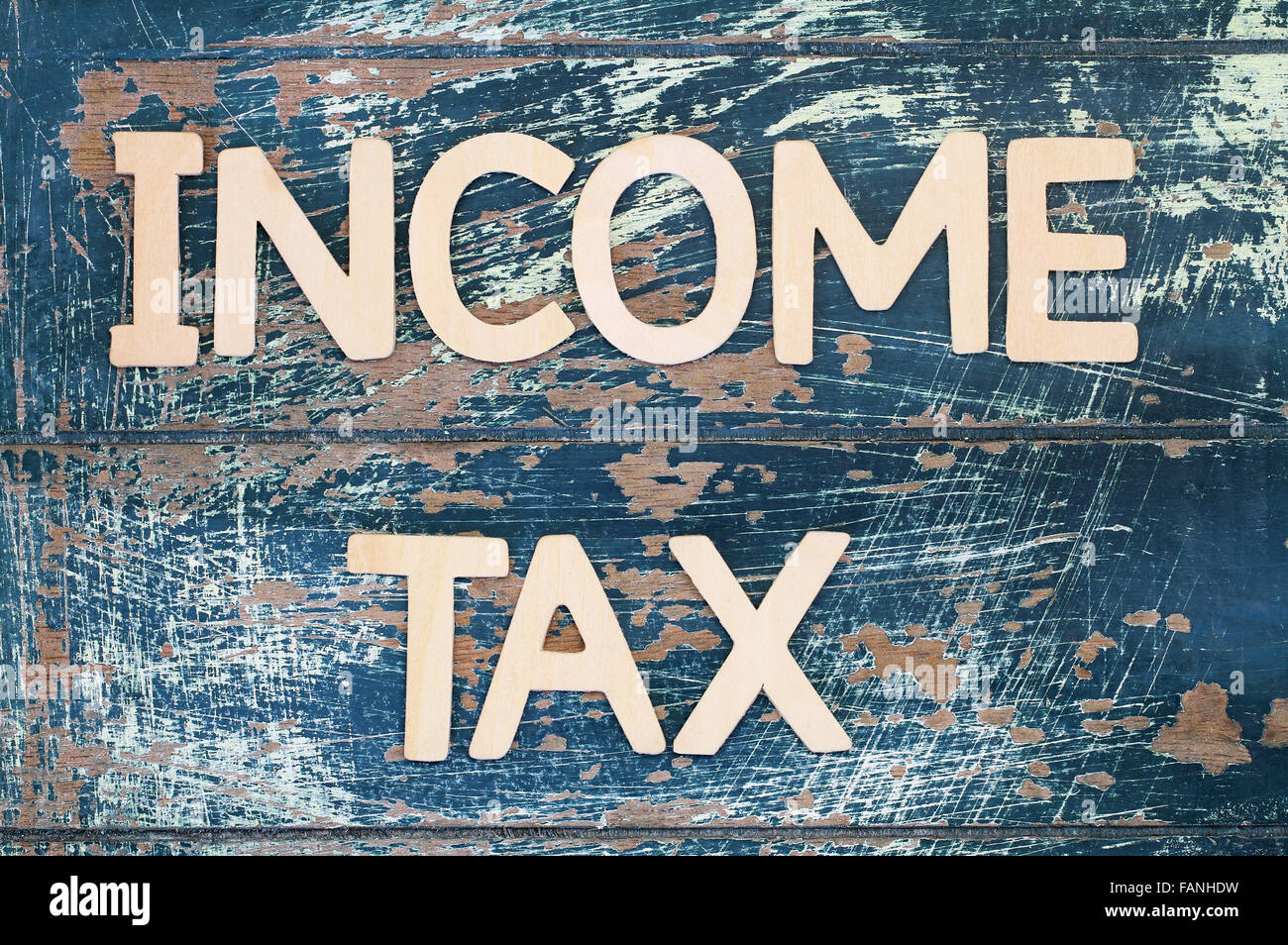 Income tax written with wooden letters on rustic surface Stock Photo ...