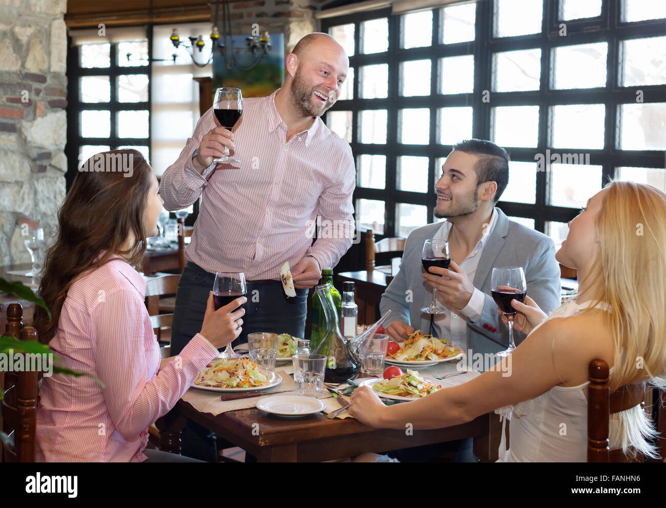 Two married couple sitting at restaurant table Stock Photo - Alamy