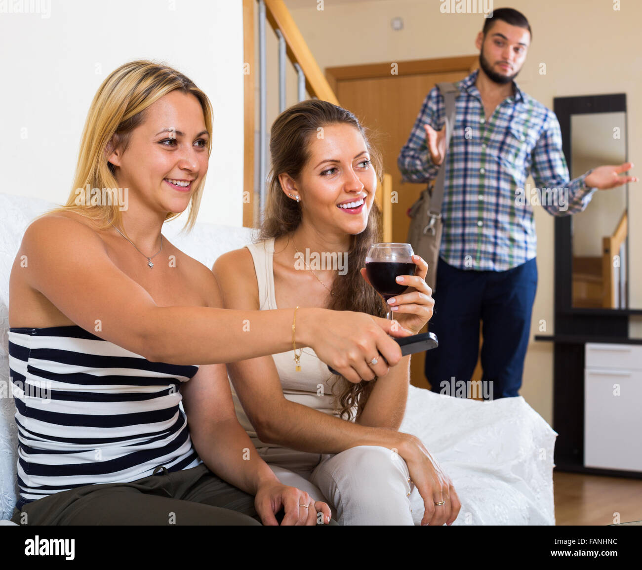 Surprised guy discovering his young girlfriend with another girl at ...