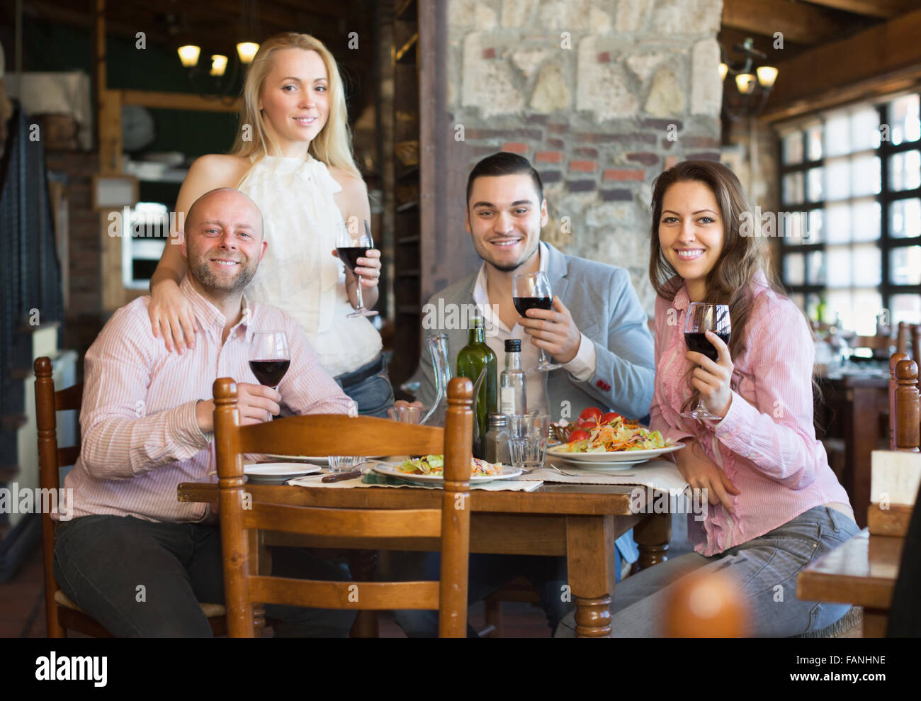 Portrait of smiling adults having dinner in restaurant Stock Photo - Alamy