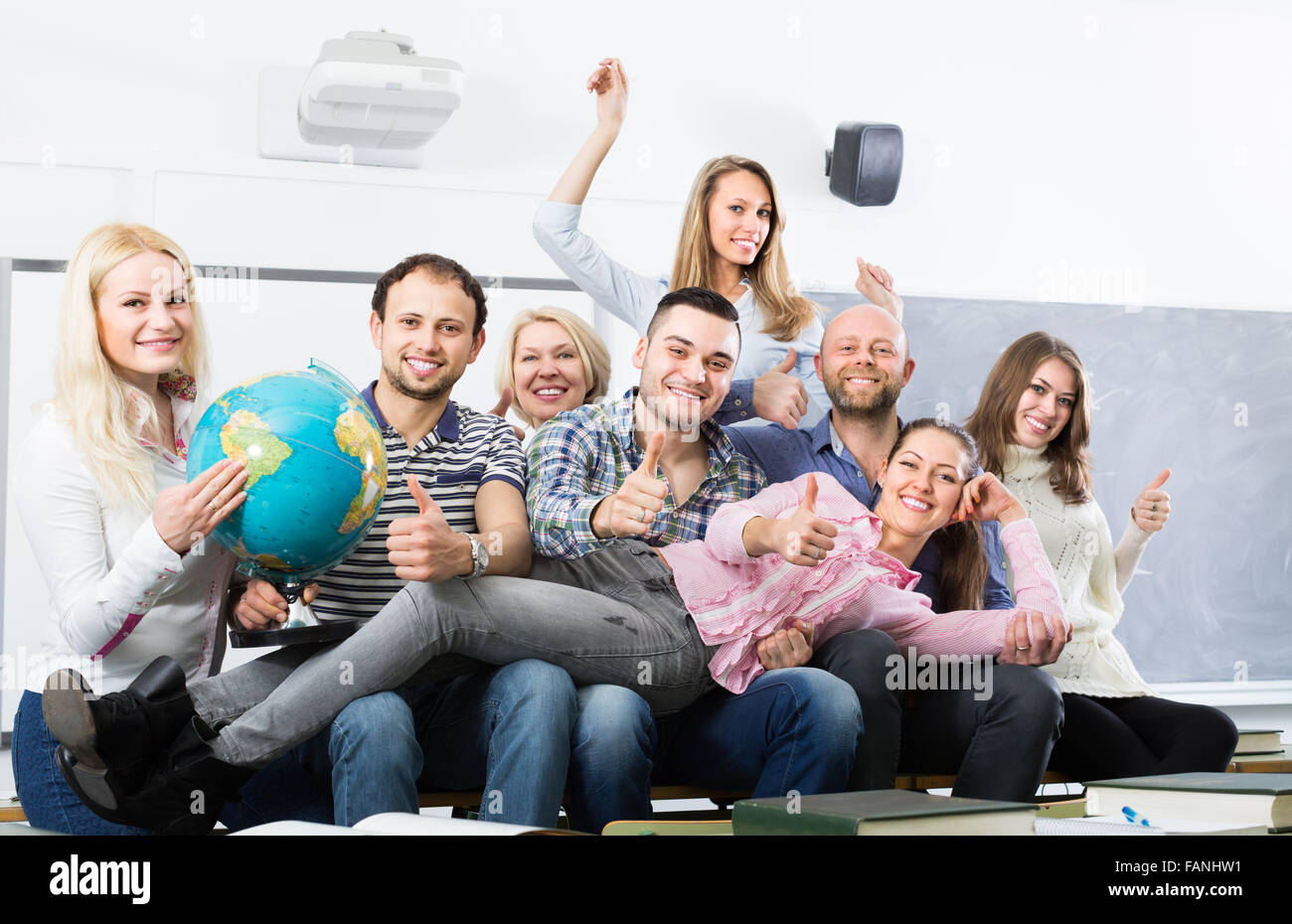 Happy smiling professionals and coach posing at training session school ...