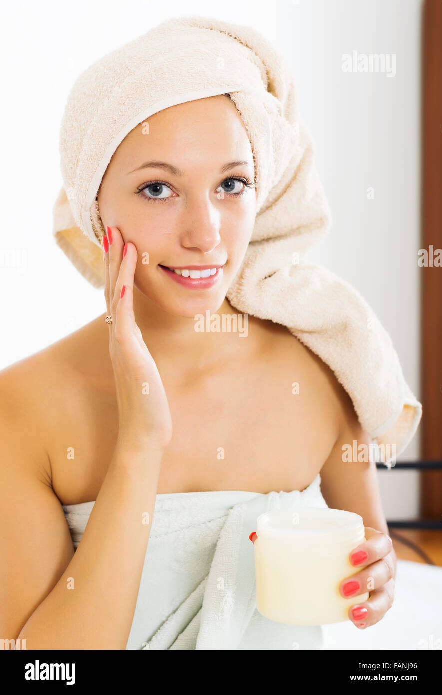 young woman putting cream on face at home Stock Photo - Alamy