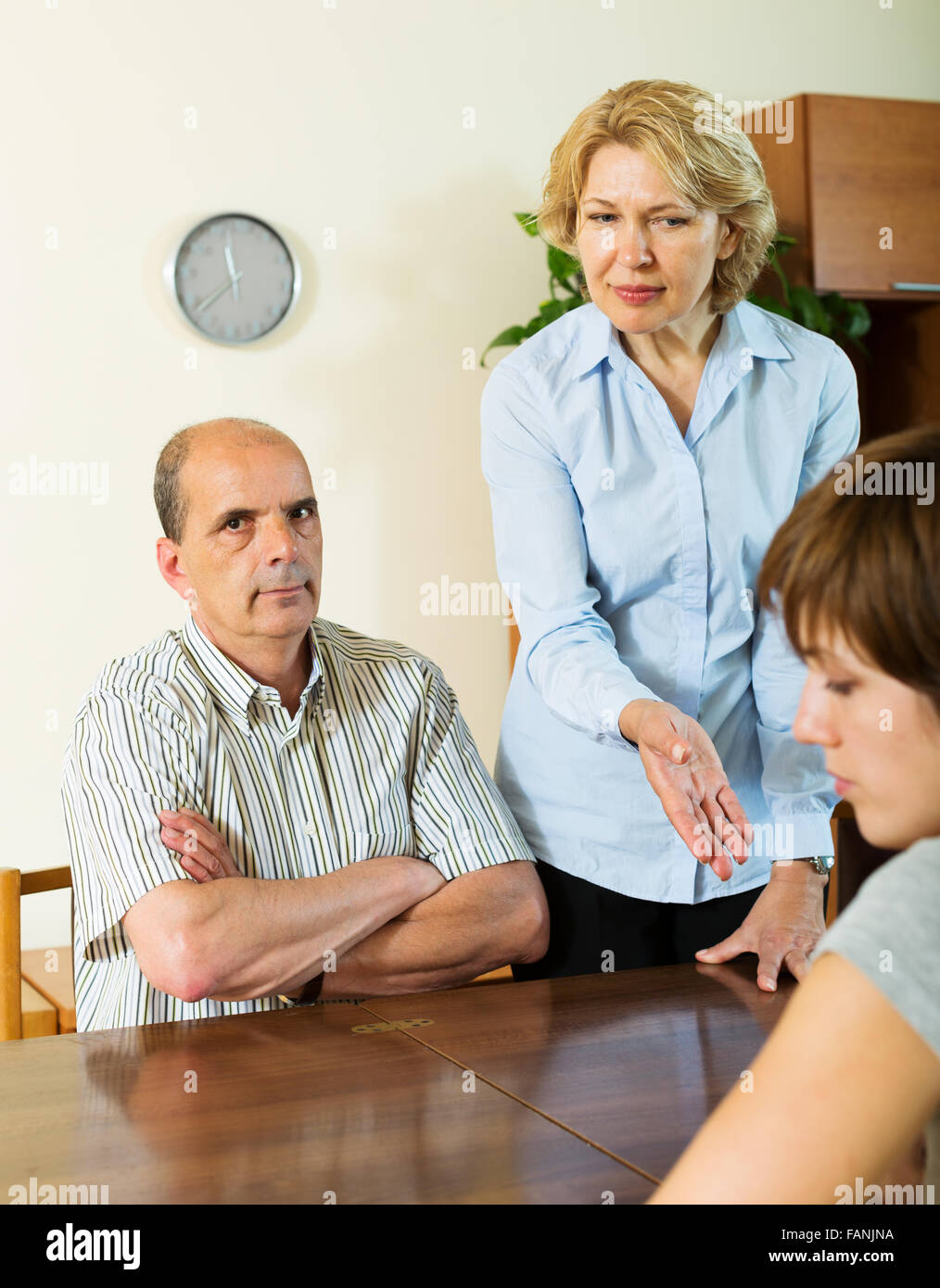 parents with adult daughter having serious conversation in home Stock ...