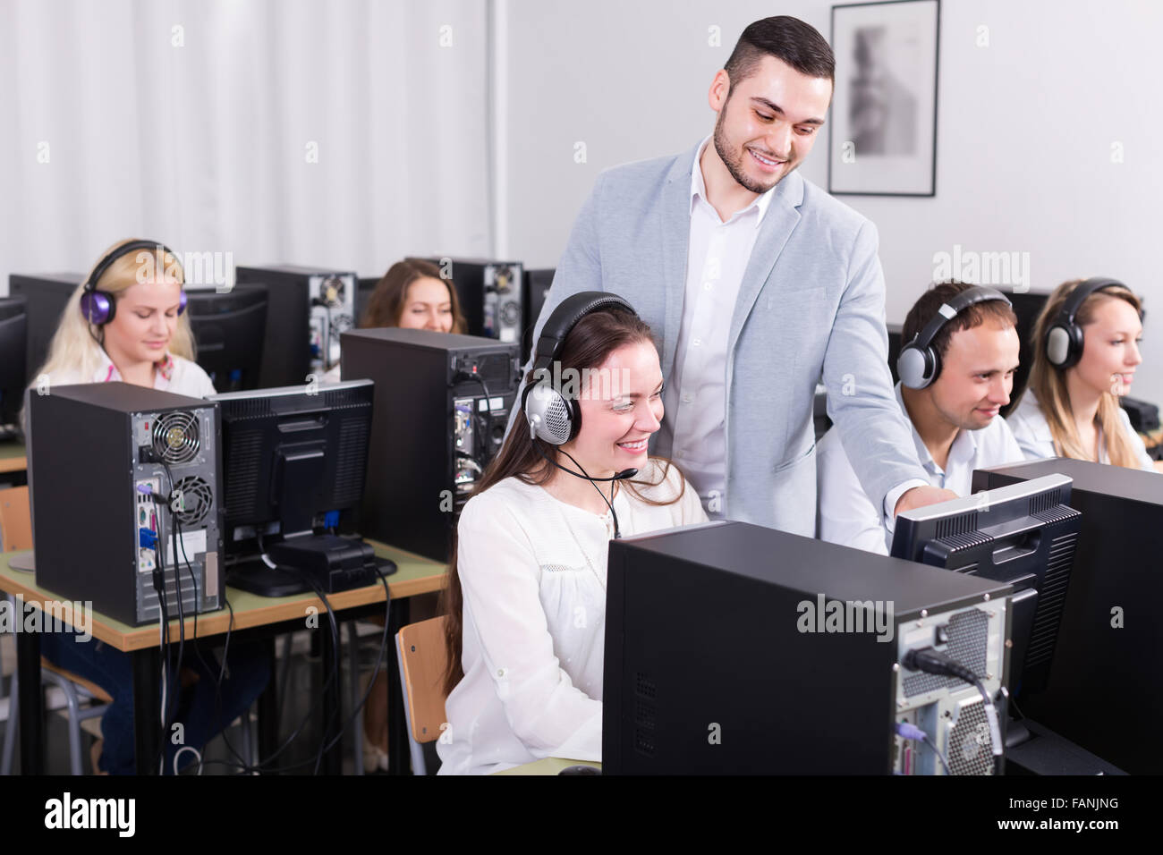 Smiling supervisor and employees of technical support line working in ...