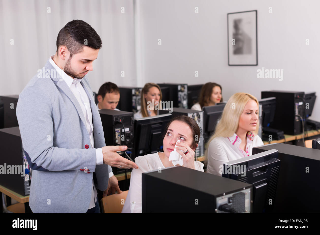 Furious supervisor scolding crying office worker at office Stock Photo ...
