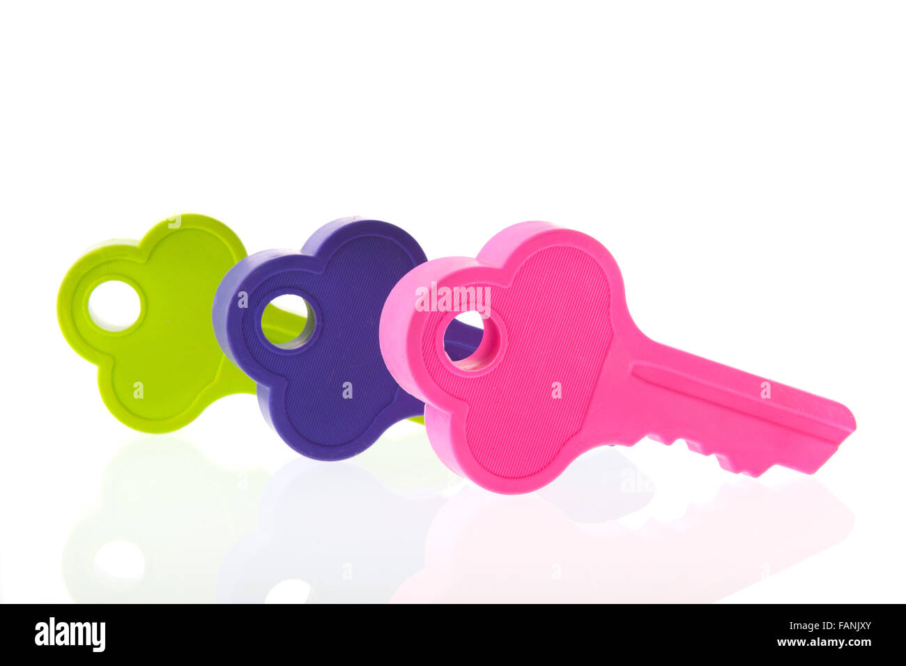 Colorful keys in green, purple and pink isolated over white background ...