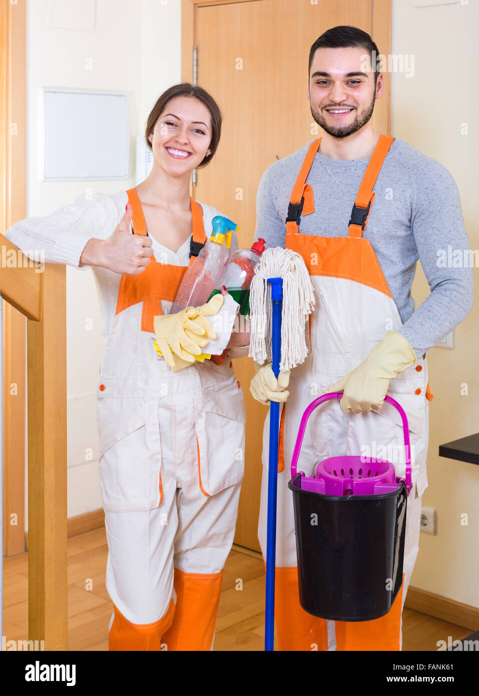 Portrait of professional cleaners team with equipment at the doors of ...