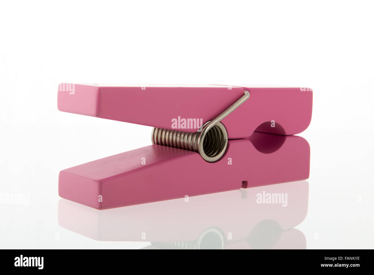 big pink clothespin isolated over white background Stock Photo - Alamy