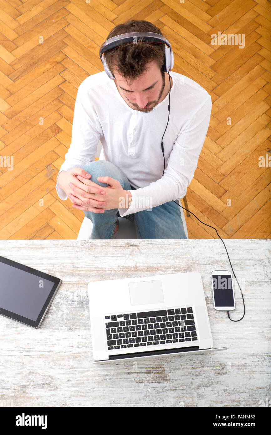 A young man listening to music on his Laptop computer Stock Photo - Alamy