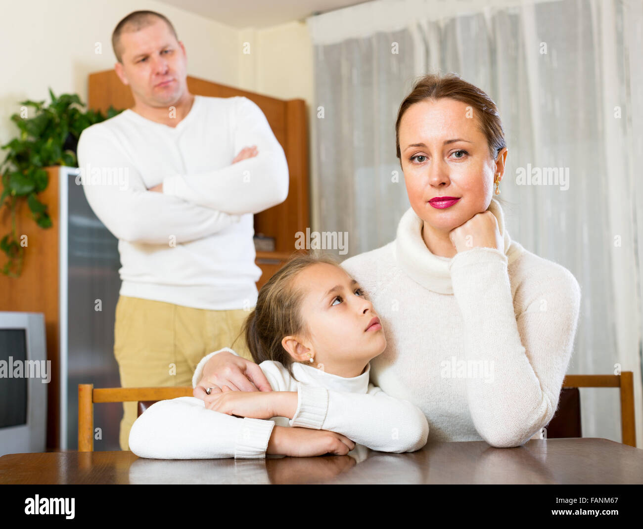 little daughter gives solace to crying mother at home and angry father ...