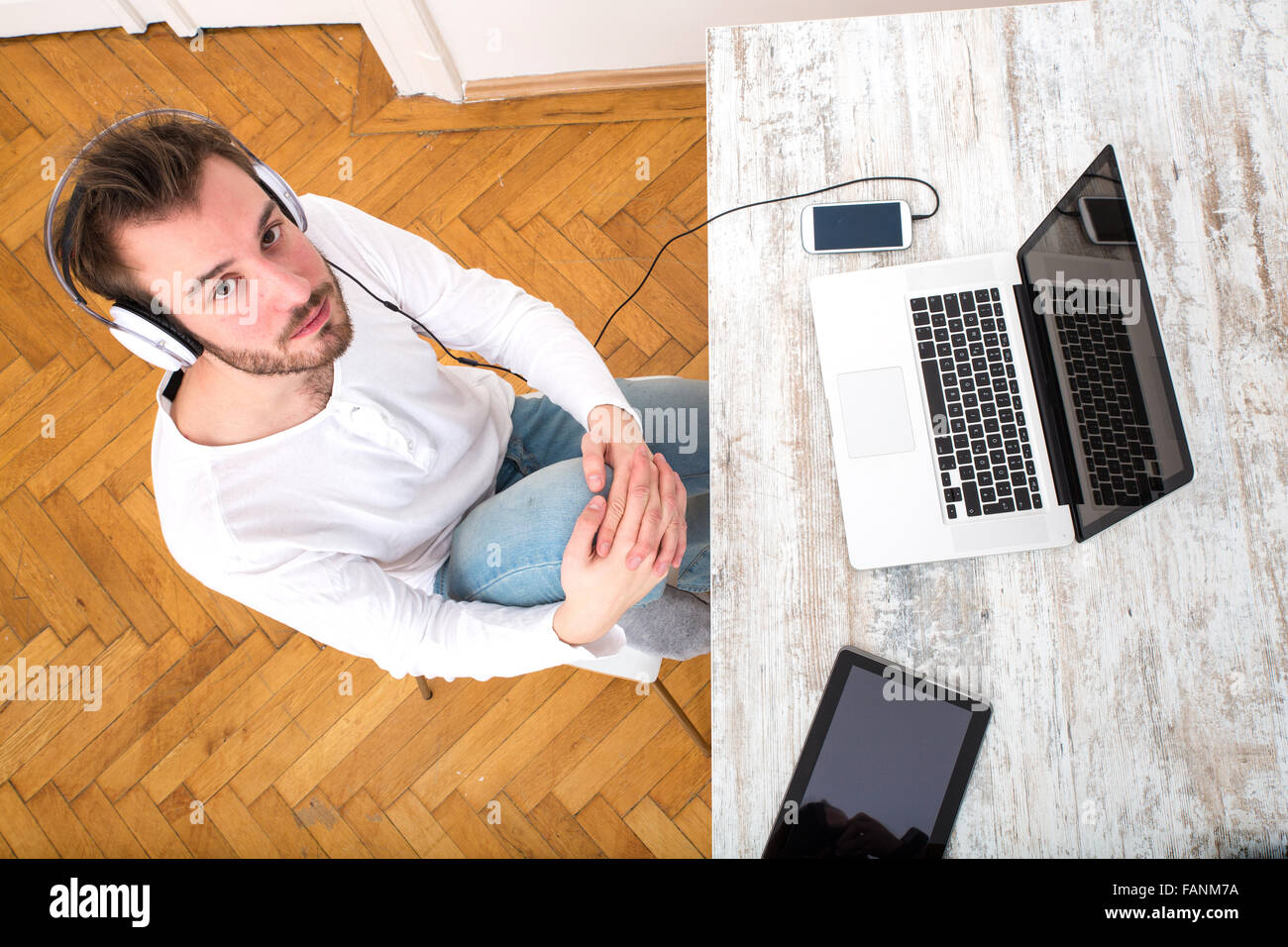 A young man listening to music on his Laptop computer Stock Photo - Alamy
