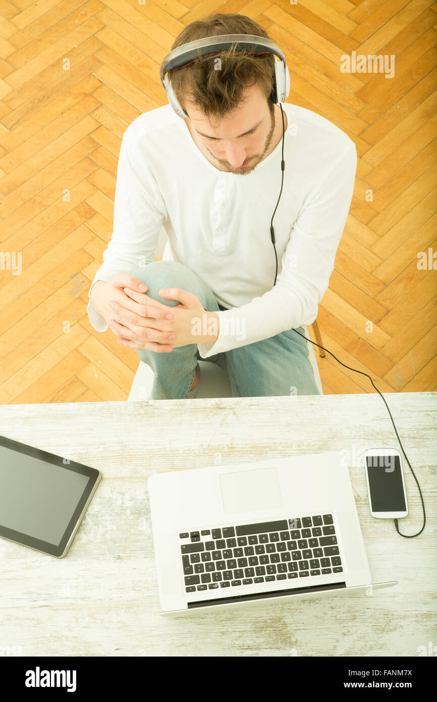 A young man listening to music on his Laptop computer Stock Photo - Alamy