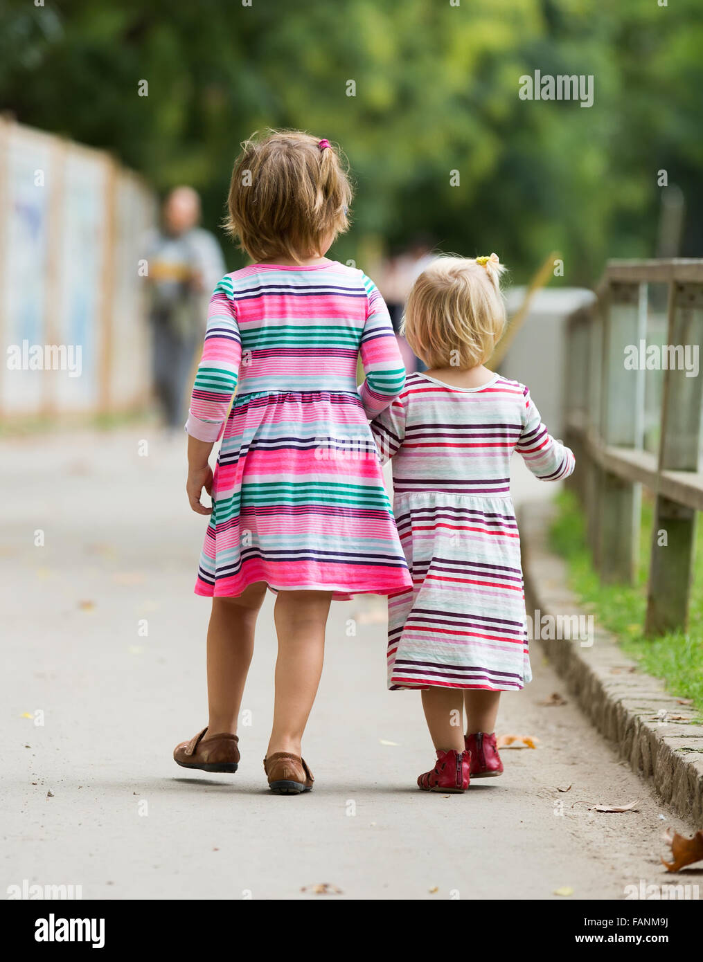 Rear view of two children in summer Stock Photo - Alamy