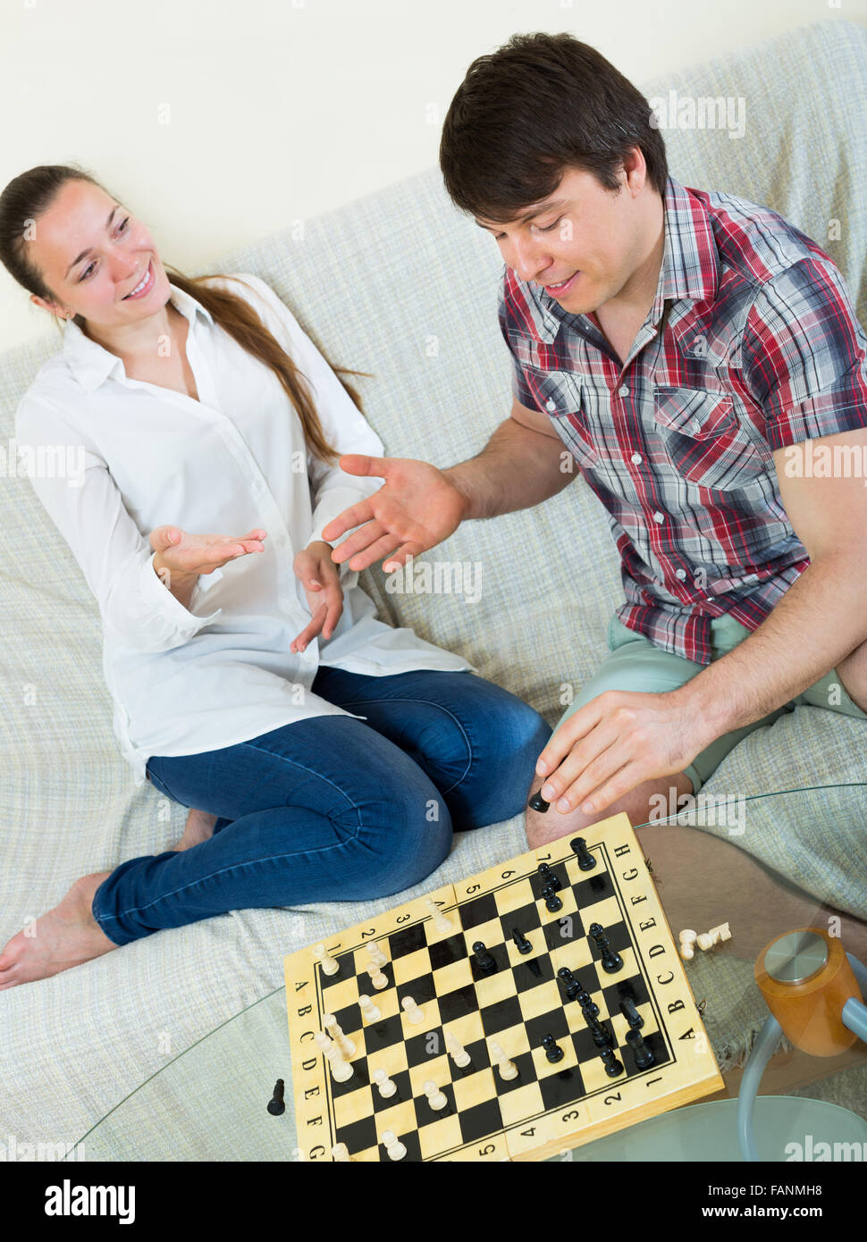 Young couple playing chess in home interior Stock Photo - Alamy