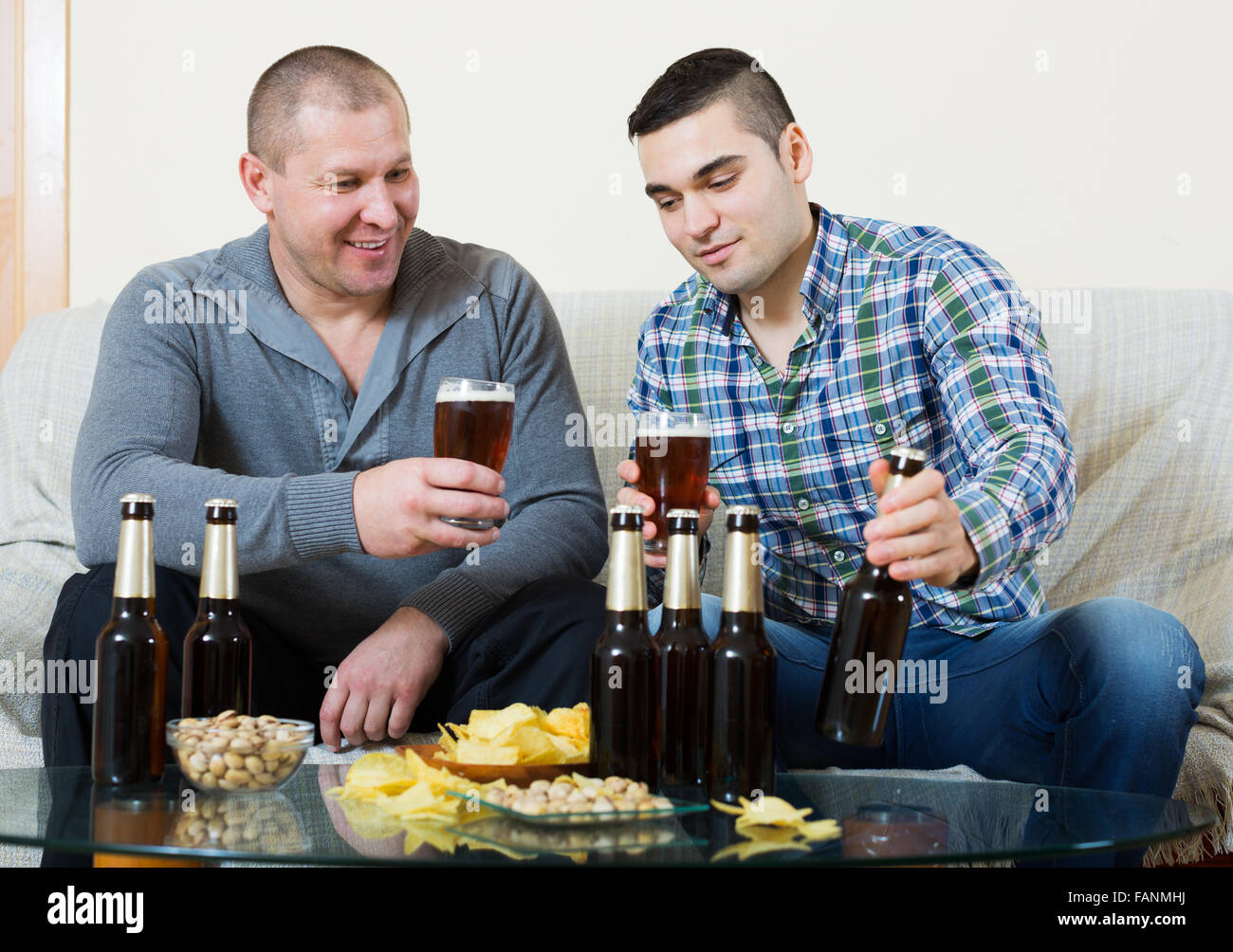 Adult man drinks beer with his young partner after work Stock Photo - Alamy