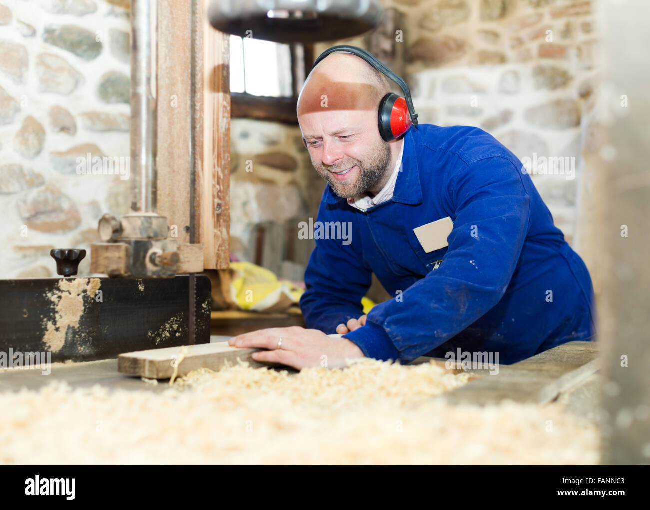 portrait smiling male worker on lathe at wood workroom Stock Photo - Alamy