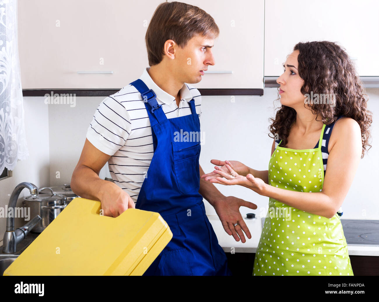 Young housewife shocked of smatter plumber coming to help Stock Photo ...