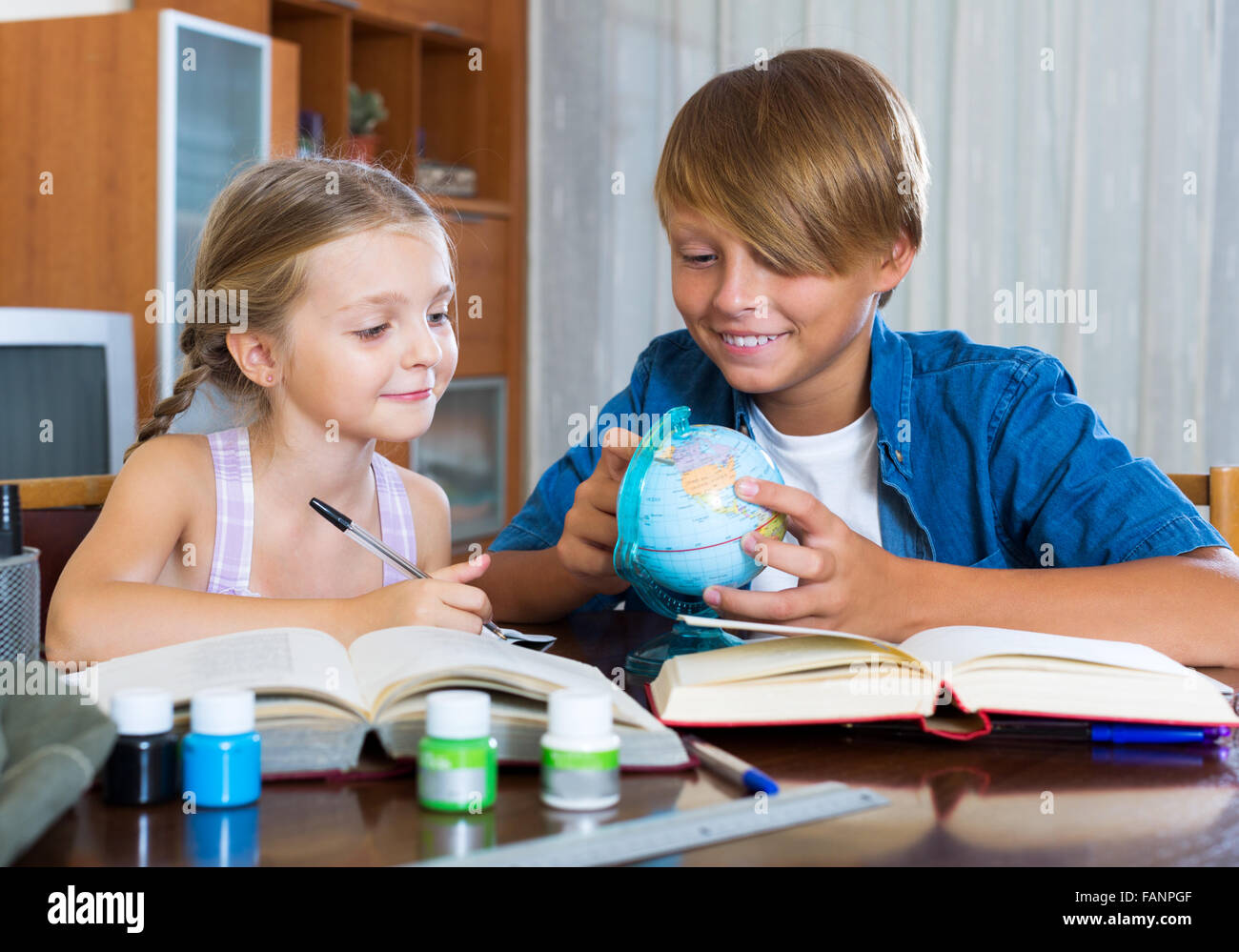 Big brother helping little girl to do homework at home Stock Photo - Alamy