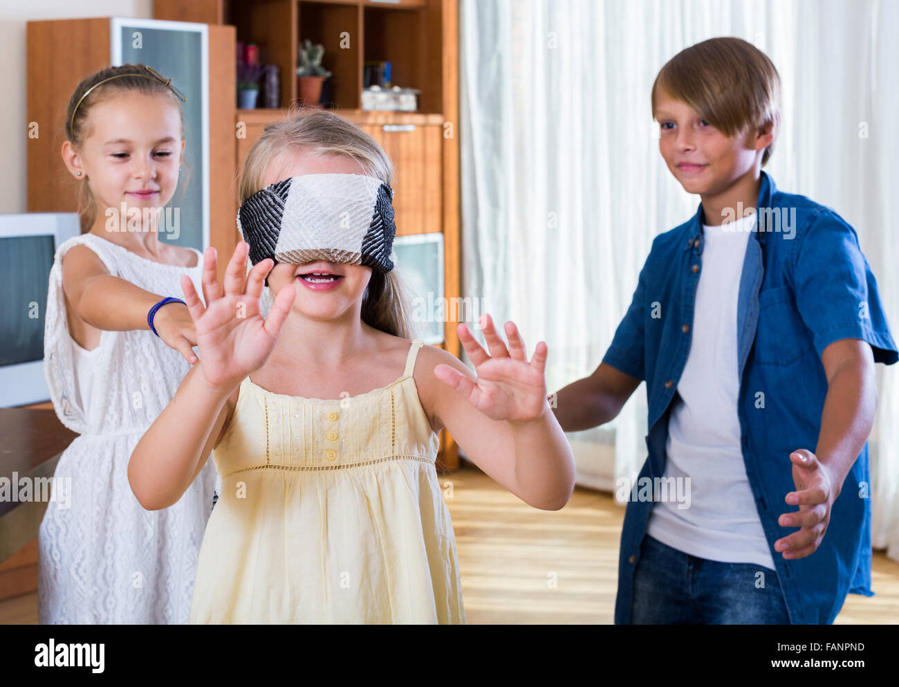 smiling european children playing at Blind man bluff indoors Stock ...