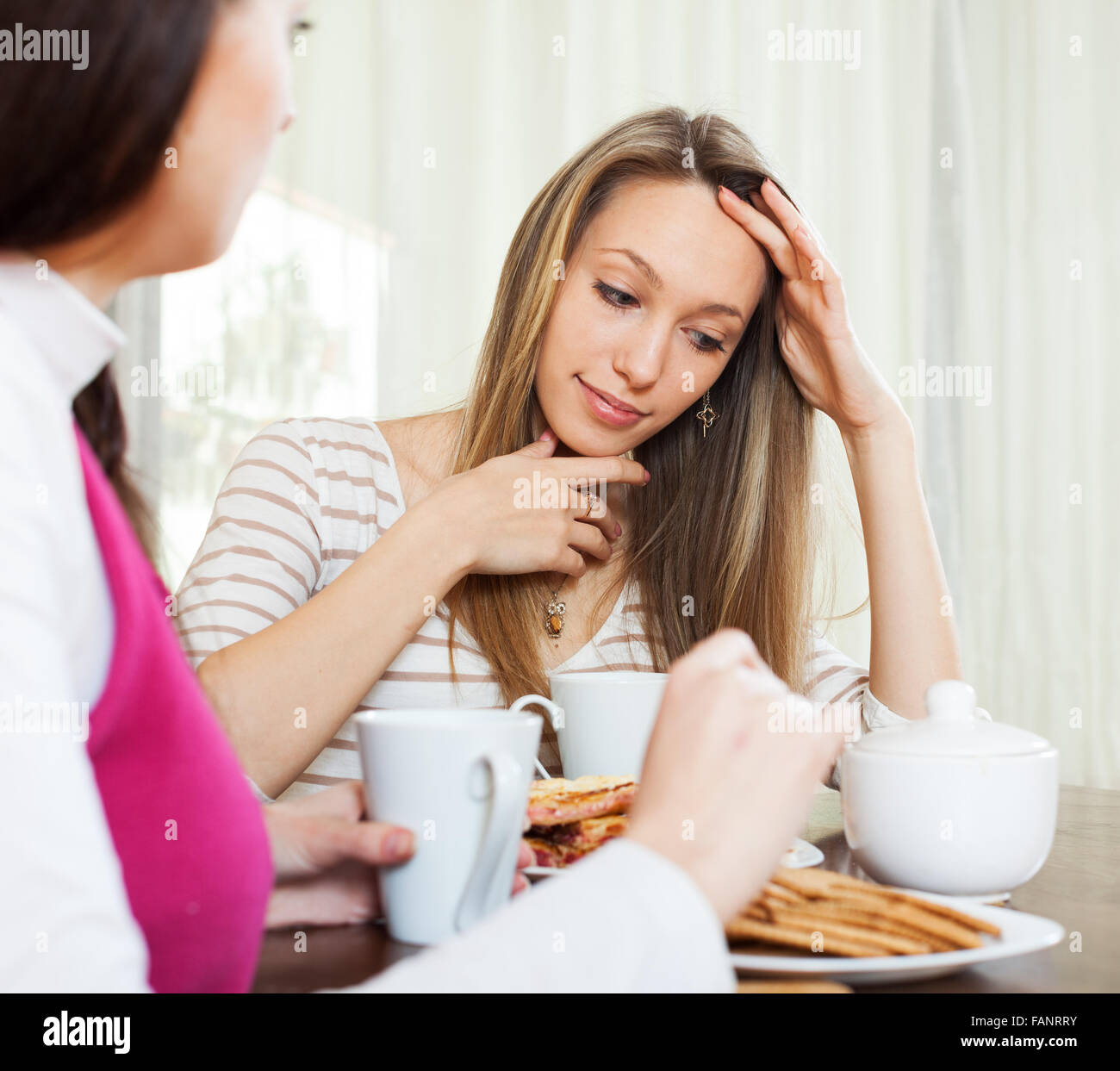 Sad woman telling to friend about her problems Stock Photo - Alamy