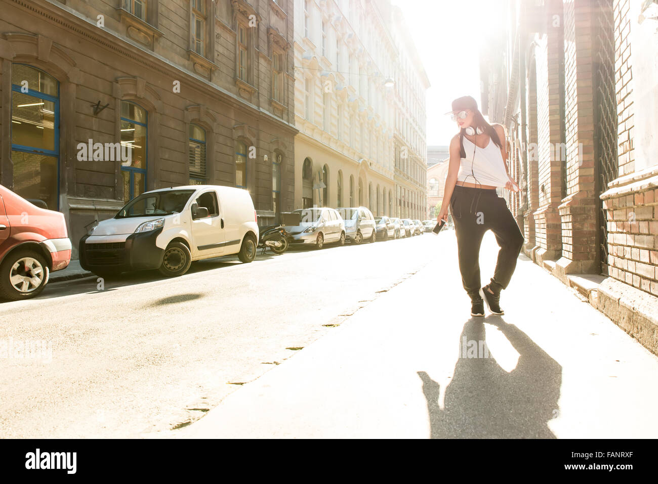 A beautiful young Hip Hop Rapper girl with Headphones in a urban ...