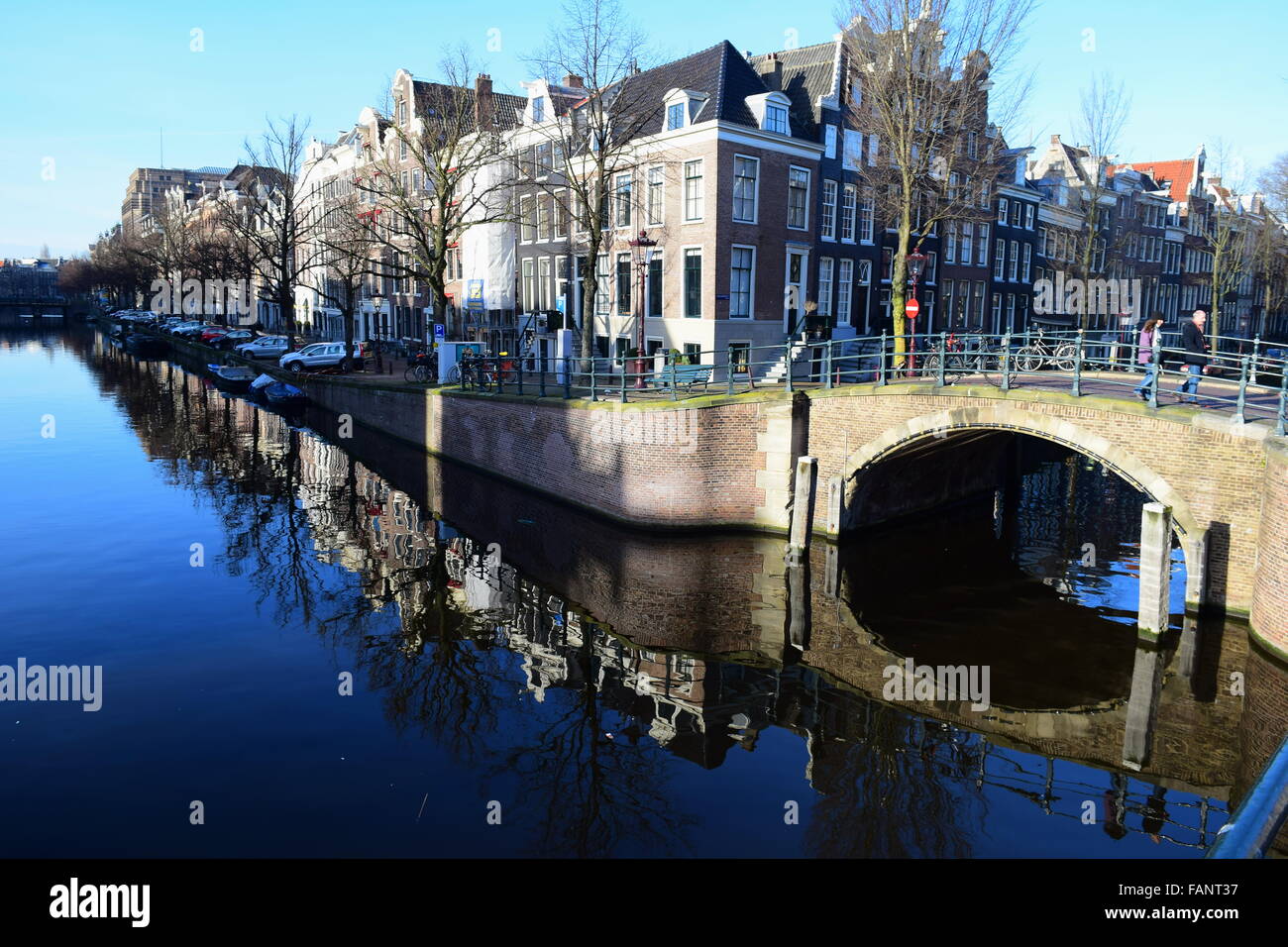 A stunning, completely calm Amsterdam canal with a full and clear ...