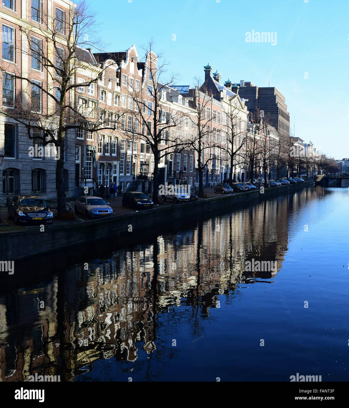 A stunning, completely calm Amsterdam canal with a full and clear ...