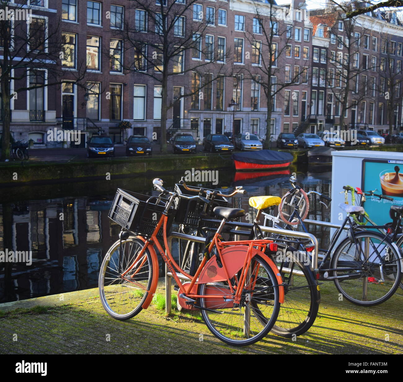 An all red bike, with a bike behind it with a bright yellow seat, both ...