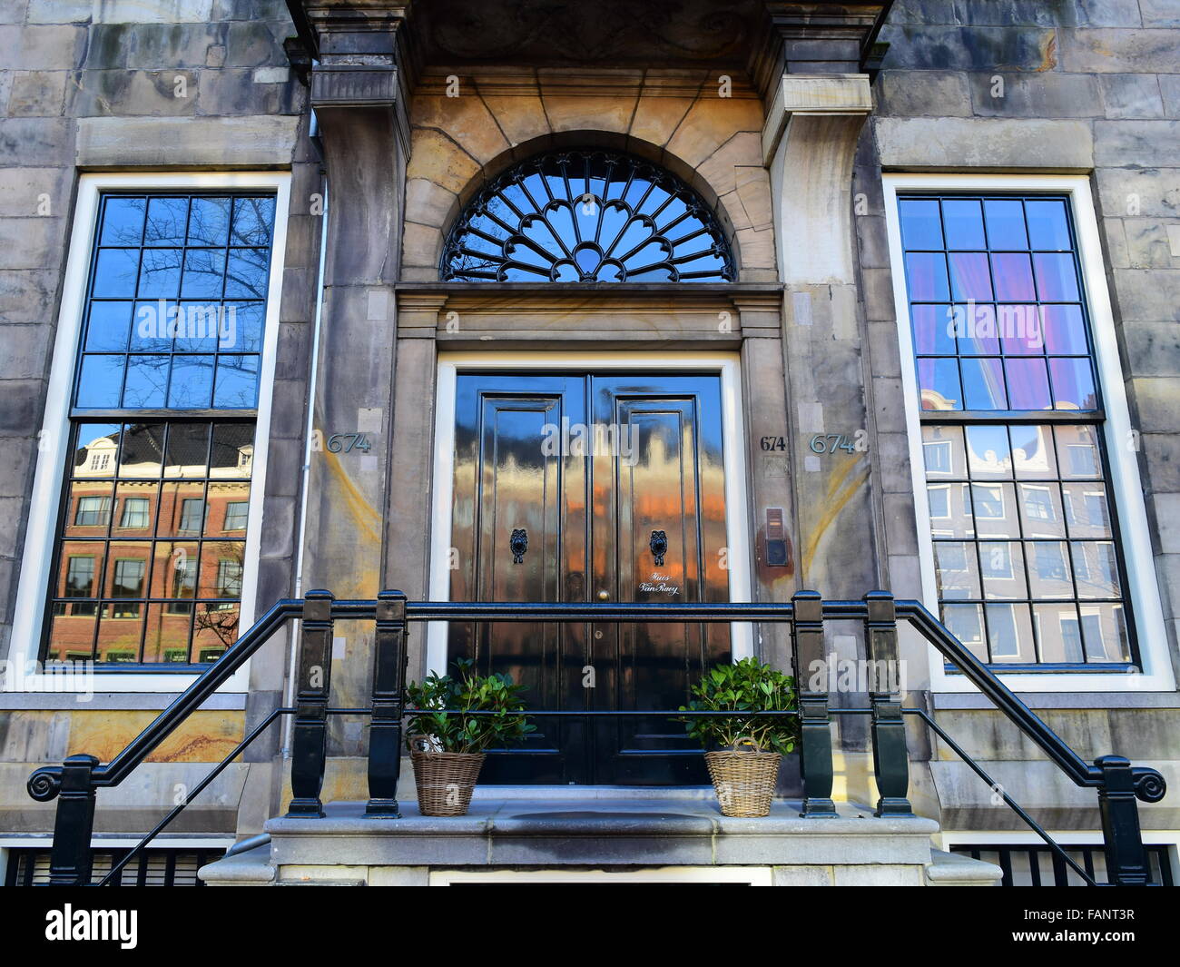 A stunning door and flanking windows in Amsterdam reflecting the row of ...