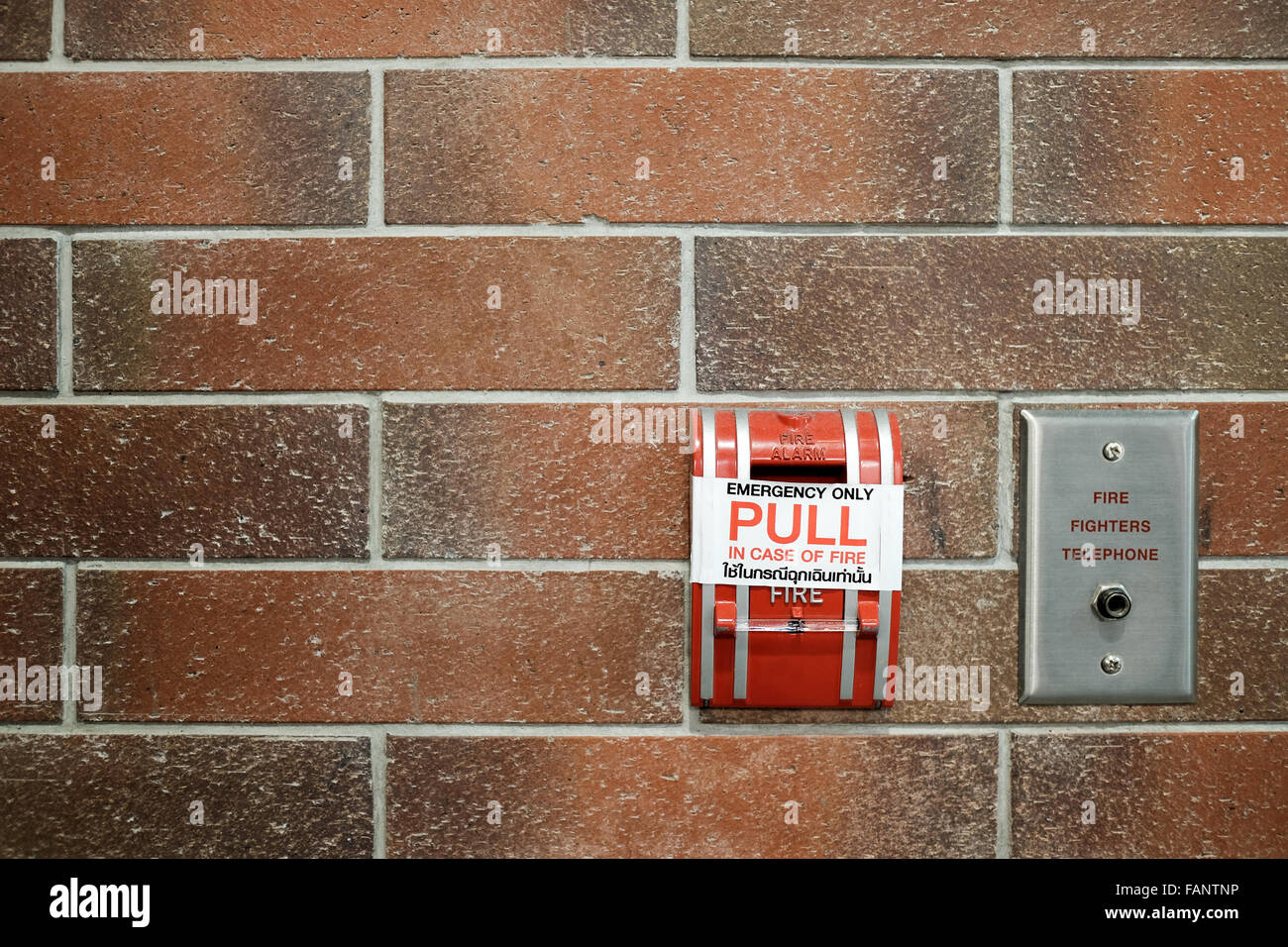 Emergency fire alarm switch on red brick wall background Stock Photo ...