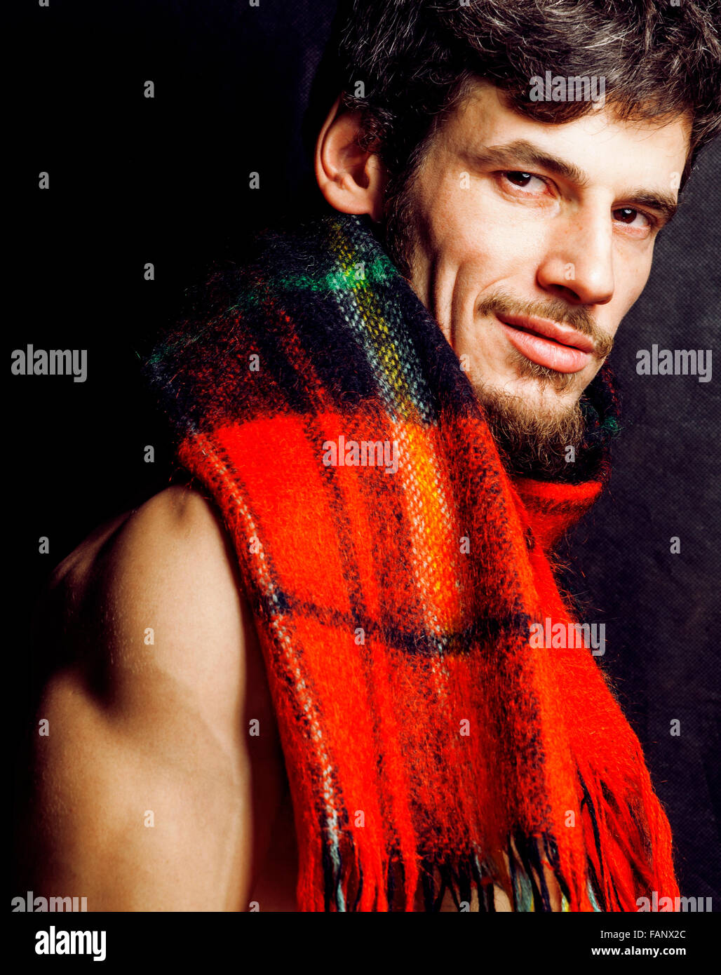 portrait of handsome man warmed up in scarf, smiling closeup dark ...