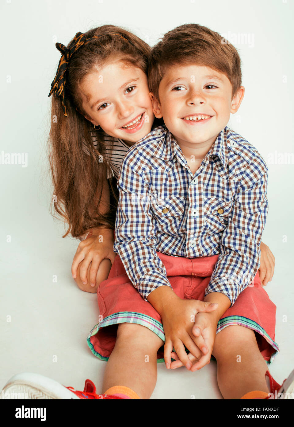 little cute boy and girl hugging playing on white background, happy family smiling twins Stock ...