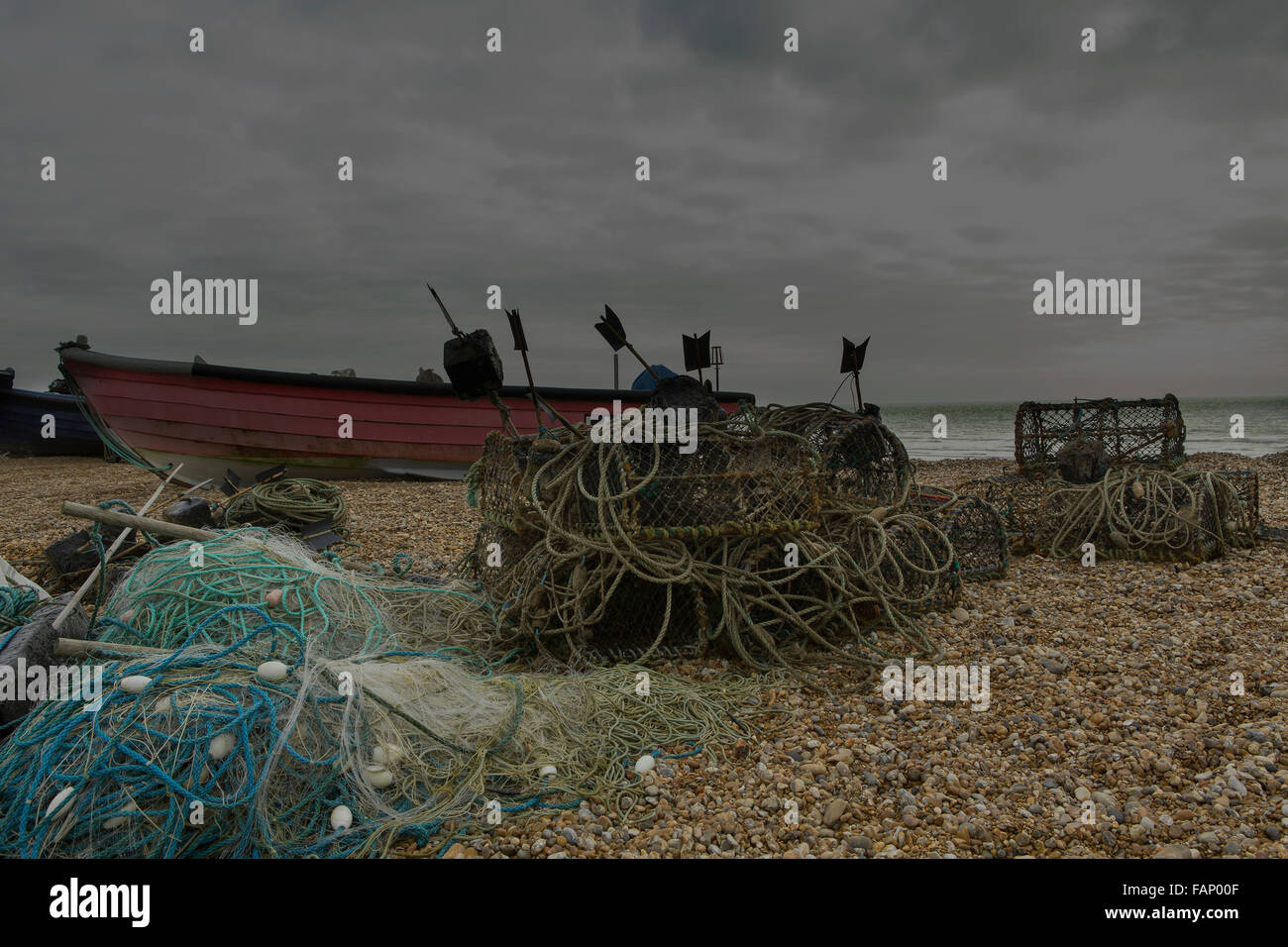 Dark and threatening sky over the beach at Bognor Regis. Fishing nets ...