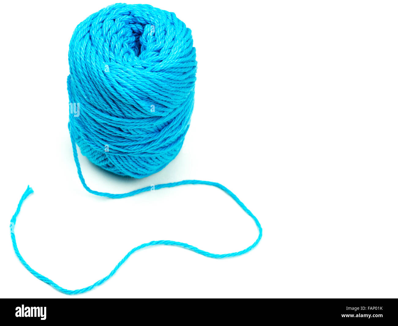 An isolated roll of blue yarn on the left side of the frame Stock Photo ...
