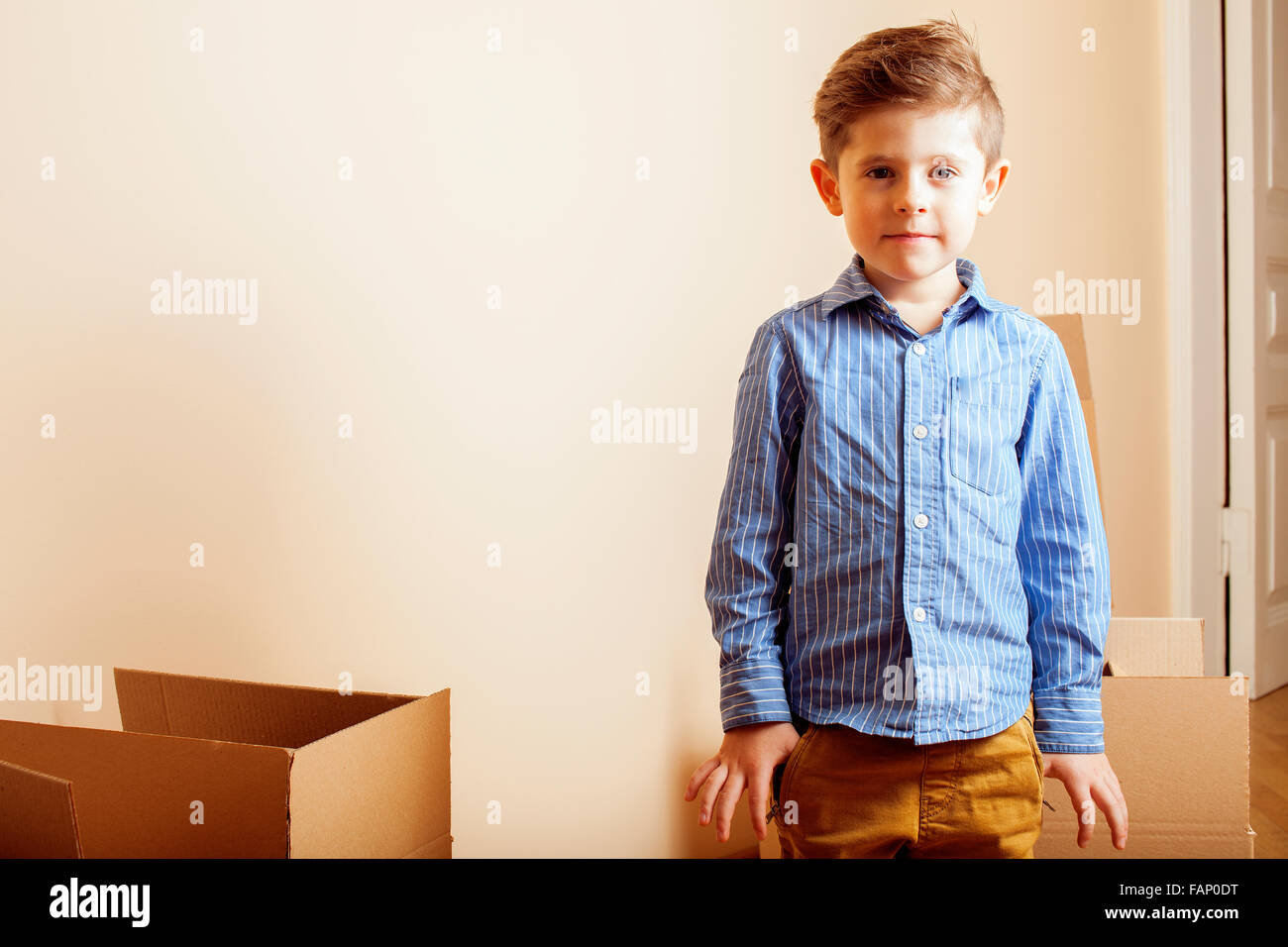 little cute boy in empty room, remoove to new house. home alone emong ...